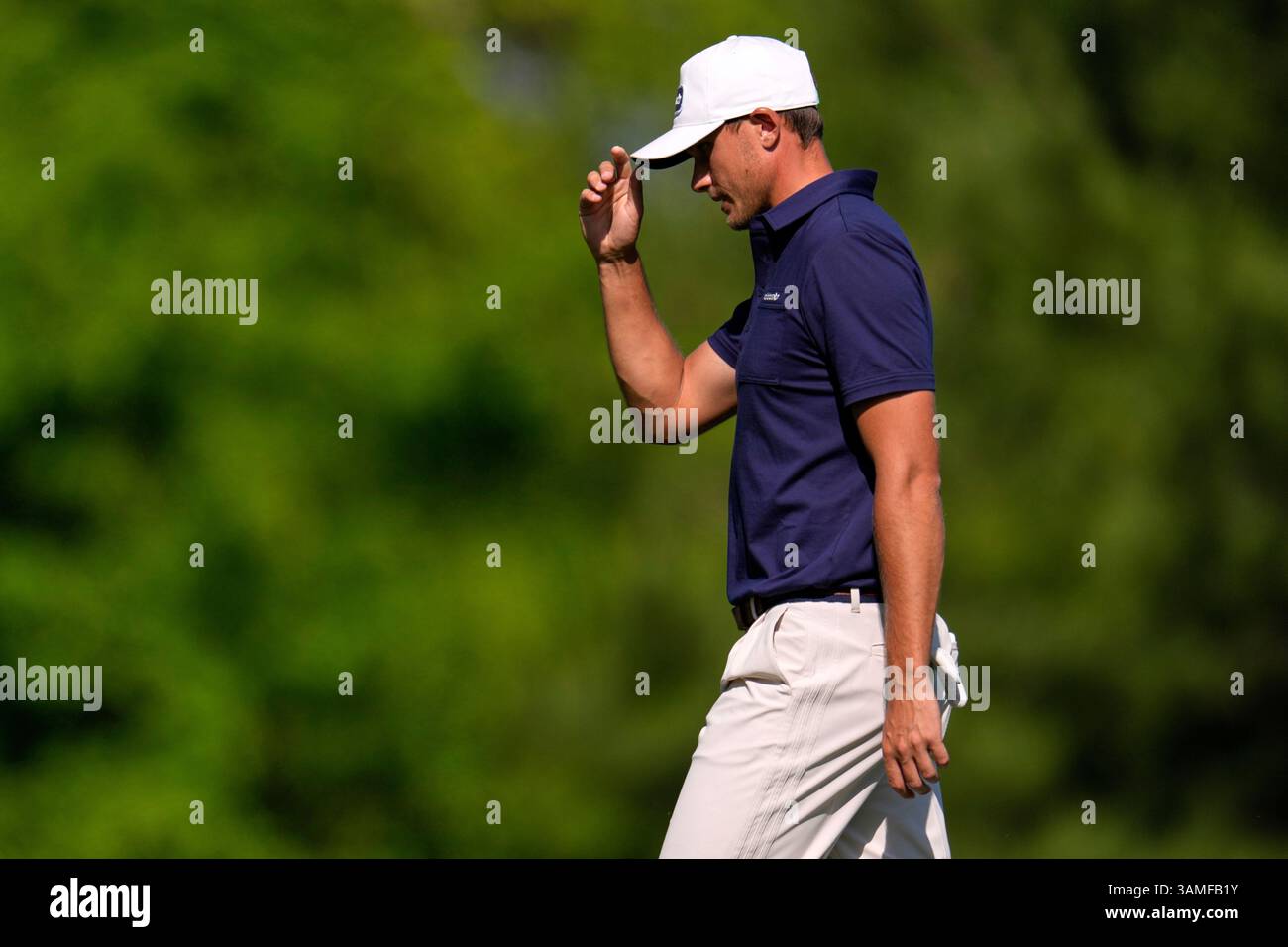 Ludvig Aberg, of Sweden, waves after making a putt on the 11th hole ...