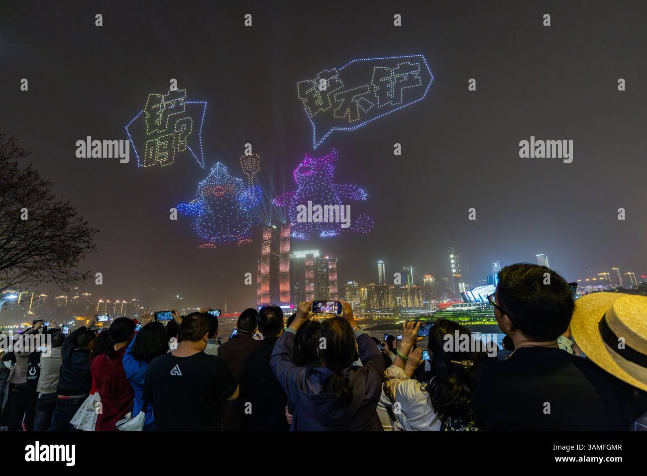 CHONGQING, CHINA - APRIL 12, 2025 - Tourists watch a drone light show ...