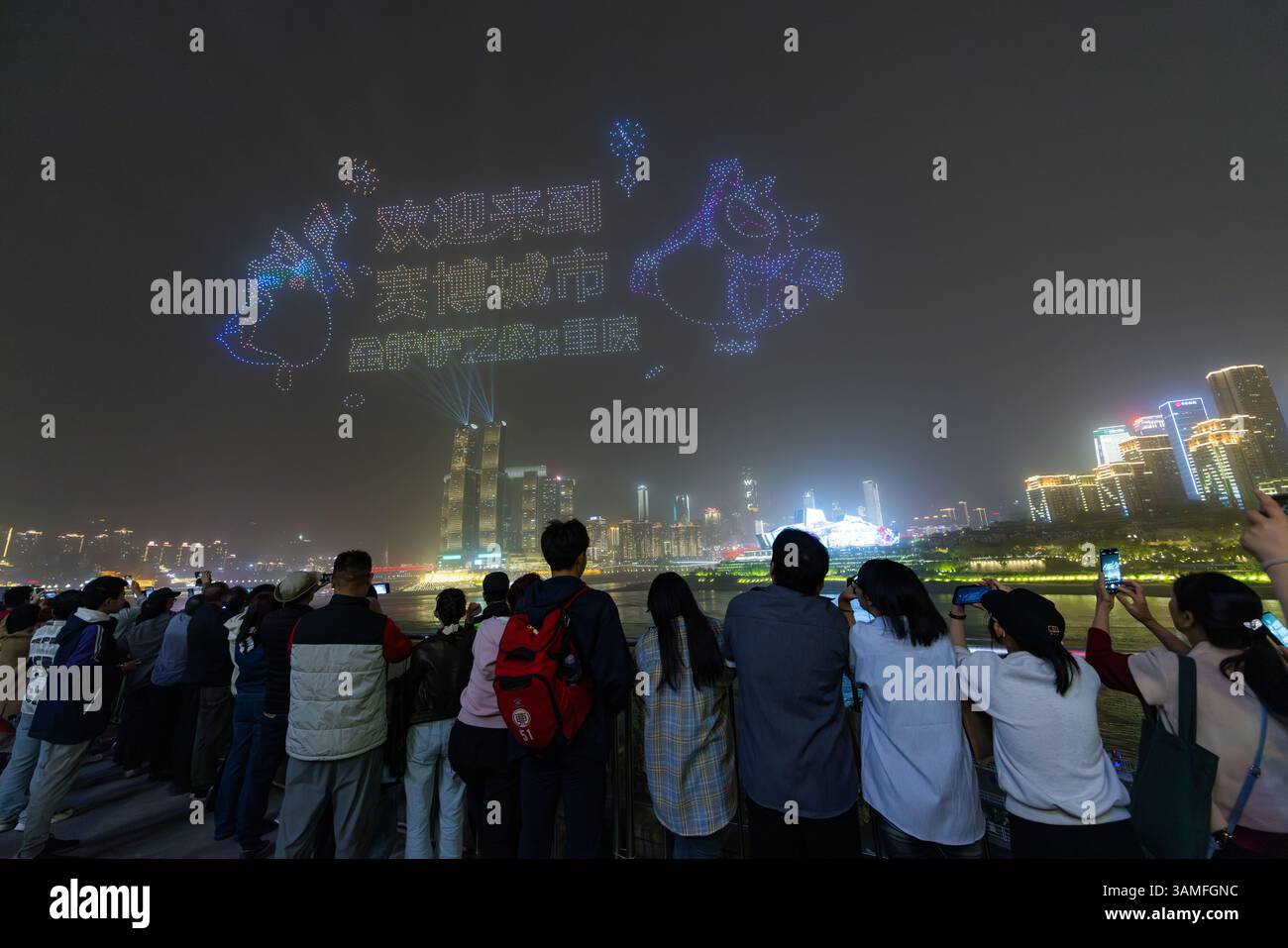 CHONGQING, CHINA - APRIL 12, 2025 - Tourists watch a drone light show ...