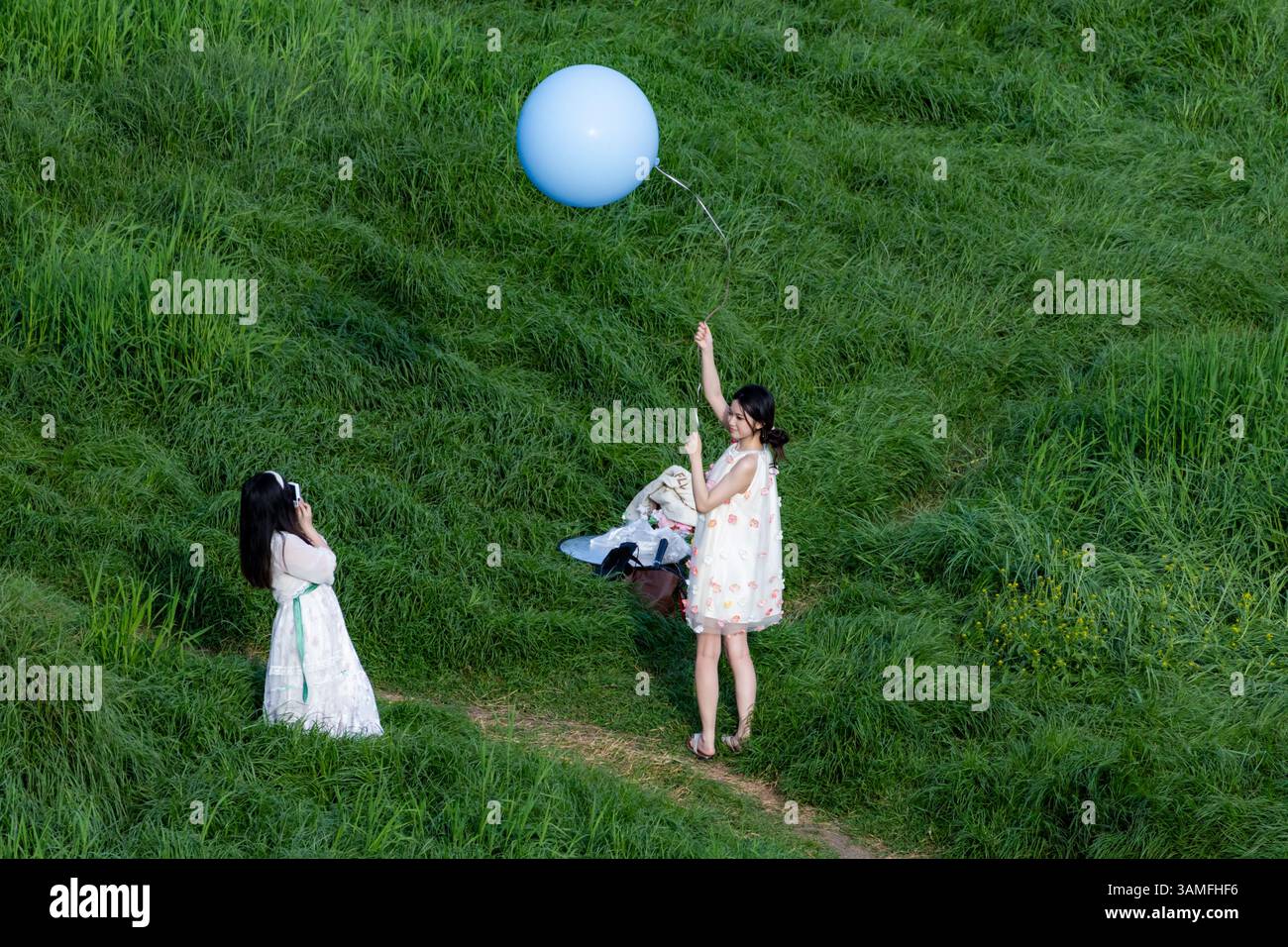CHONGQING, CHINA - APRIL 13, 2025 - Tourists camp on Jiangxin island as ...