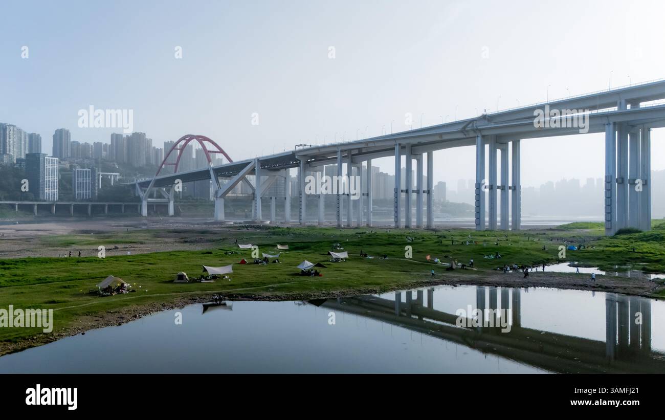 CHONGQING, CHINA - APRIL 13, 2025 - Tourists camp on Jiangxin island as ...