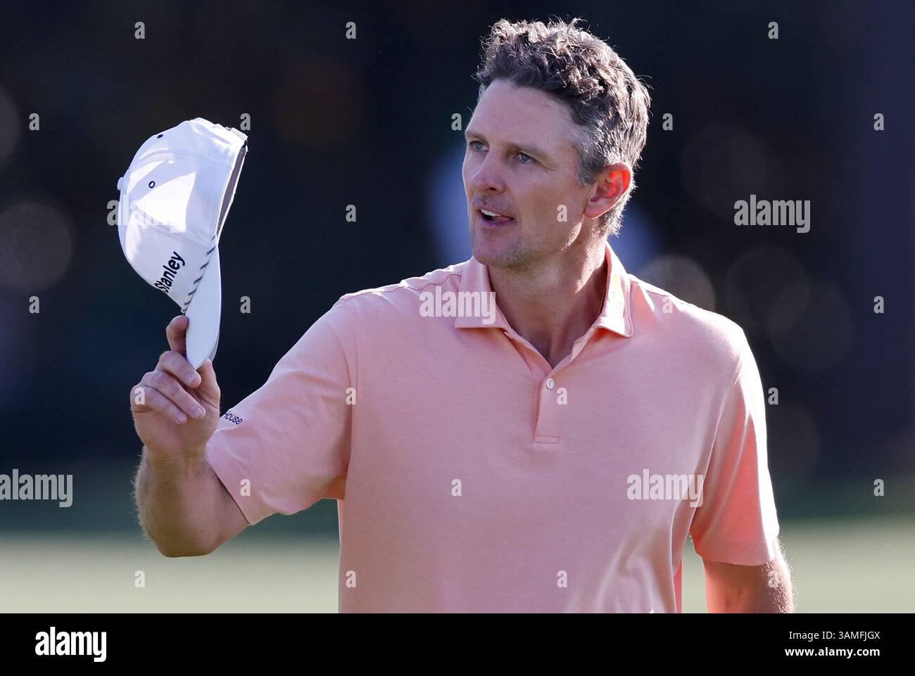 Justin Rose of England tips his cap as he walks up to the 18th green ...