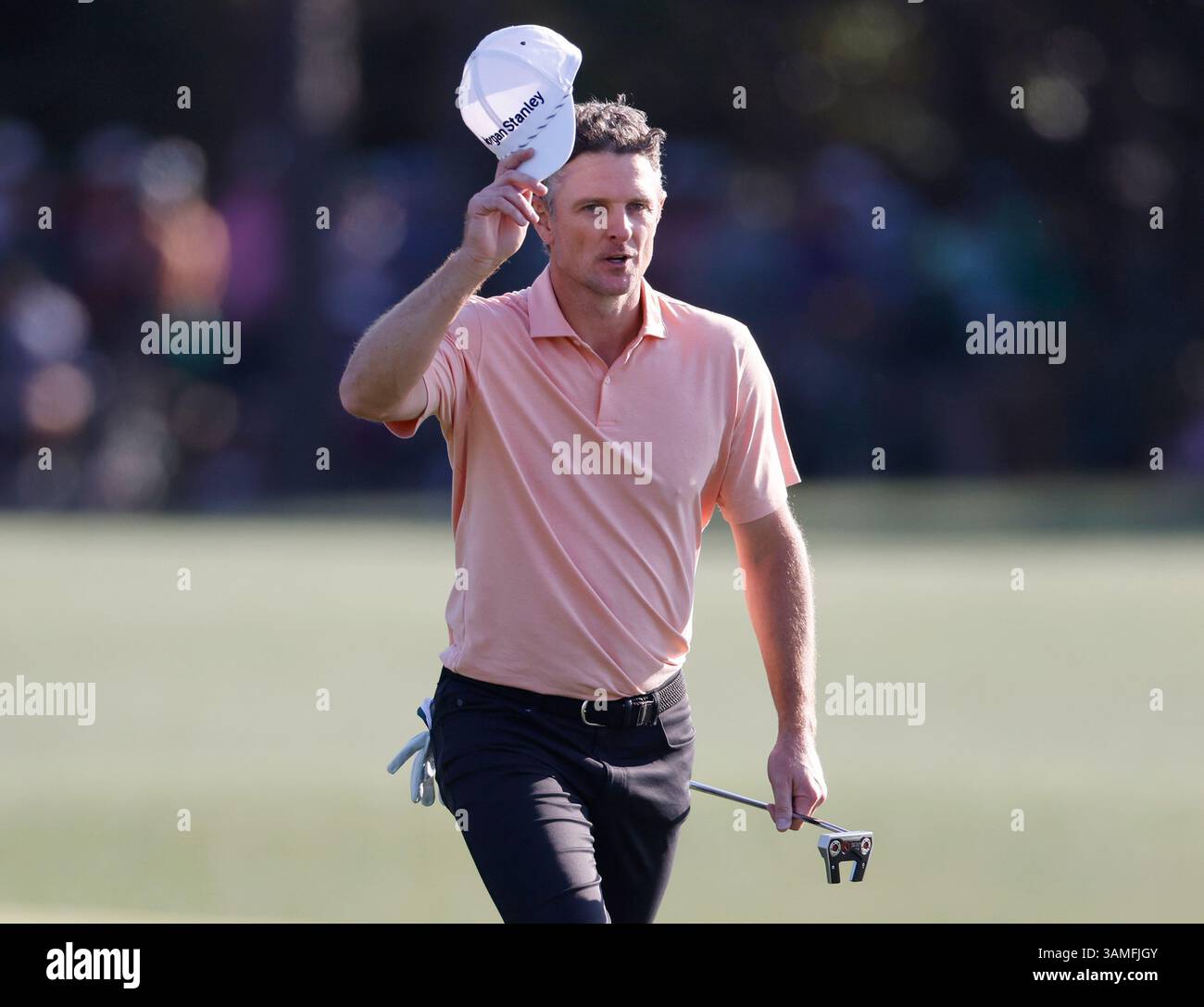 Justin Rose of England tips his cap as he walks up to the 18th green ...