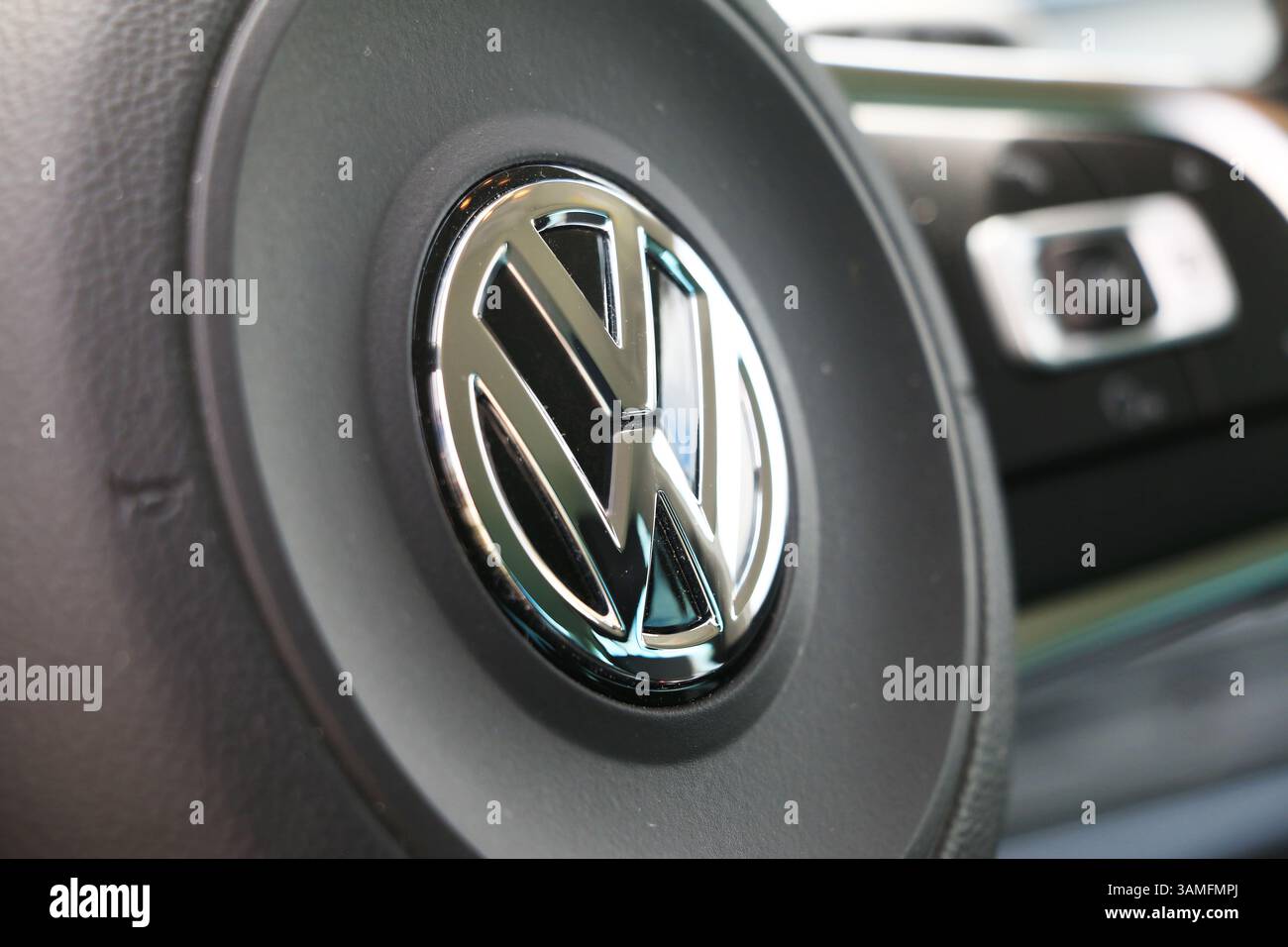 Volkswagen steering wheel emblem in modern car interior Stock Photo - Alamy