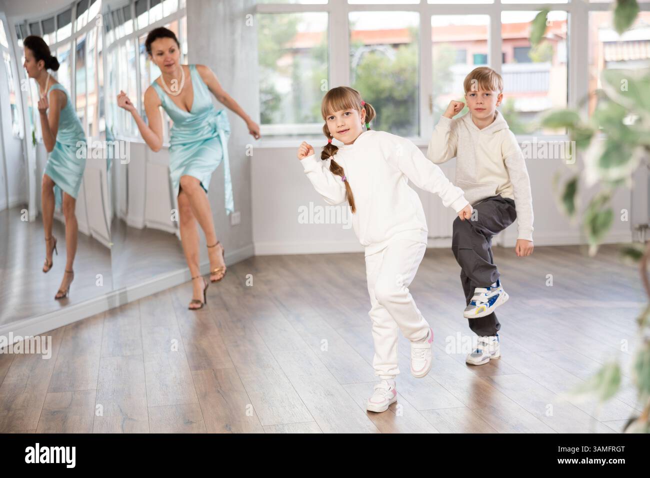 Boy and girl train to dance contemporary vigorous boogie woogie during ...