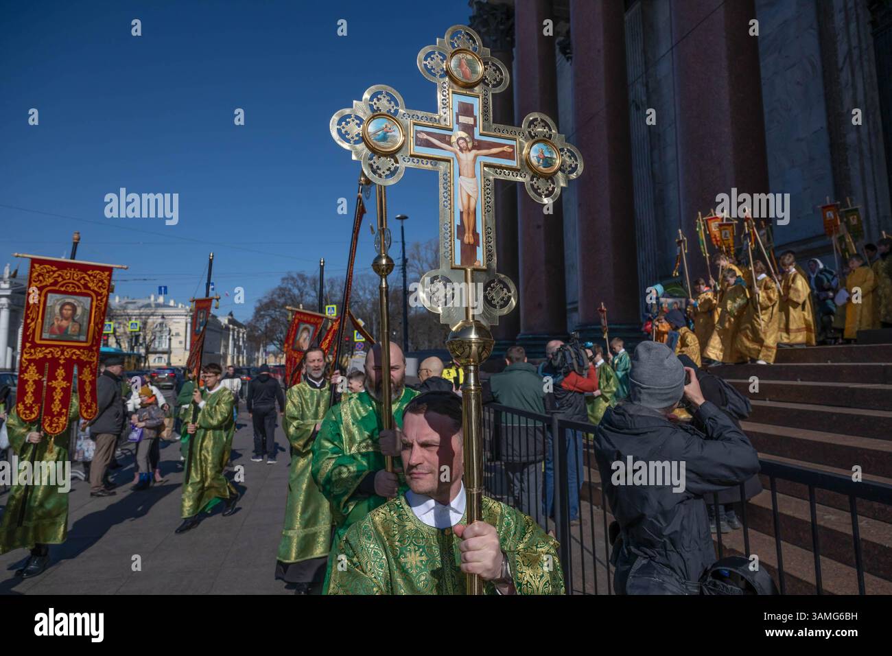 Banner bearers carry an Orthodox crucifix and banners during the Palm ...
