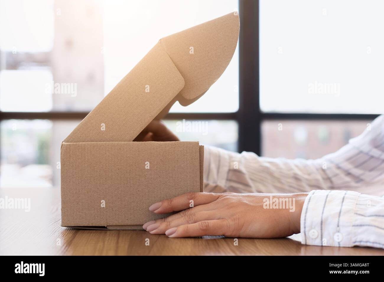 Woman opening box with new parcel, close-up Stock Photo - Alamy