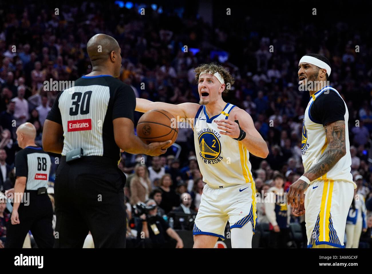 Golden State Warriors guard Brandin Podziemski (2) talks to referee John Butler (30) during ...