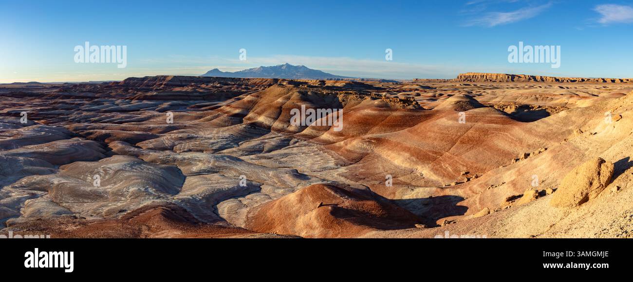 The Henry Mountains rise above the colorful Bentonite Hills during a ...
