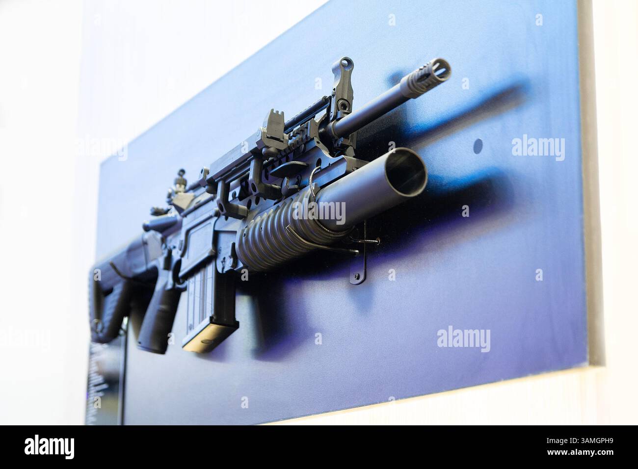 Automatic rifle with a high grenade launcher on the window of the ...