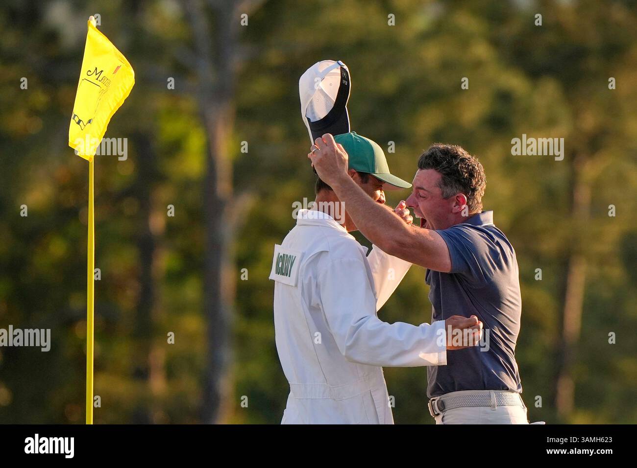 Rory McIlroy, of Northern Ireland, hugs caddie Harry Diamond, left ...