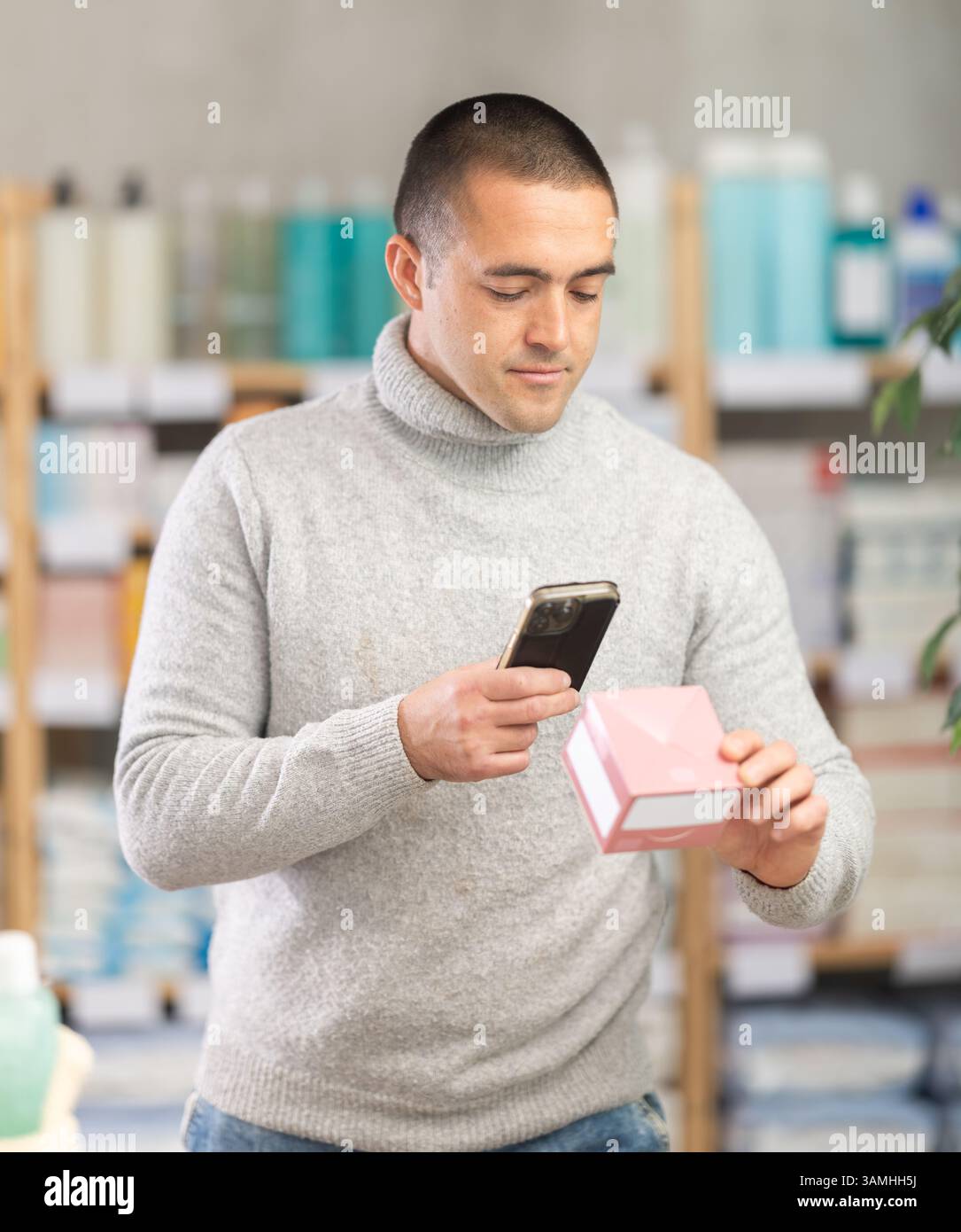 Man scans code on package of ointment to check expiration date Stock ...