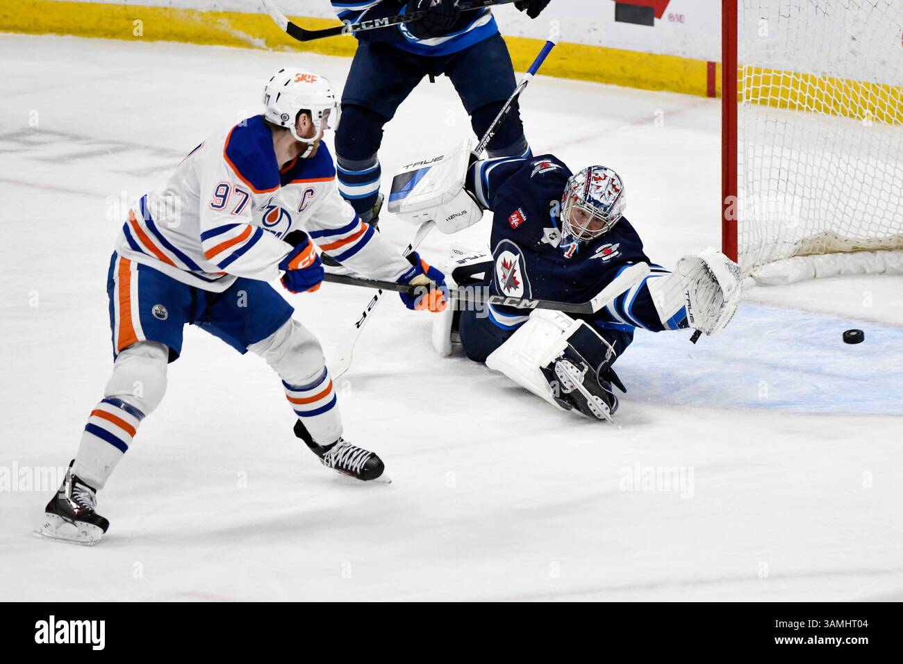 Edmonton Oilers' Connor McDavid (97) shoots the puck wide past Winnipeg ...