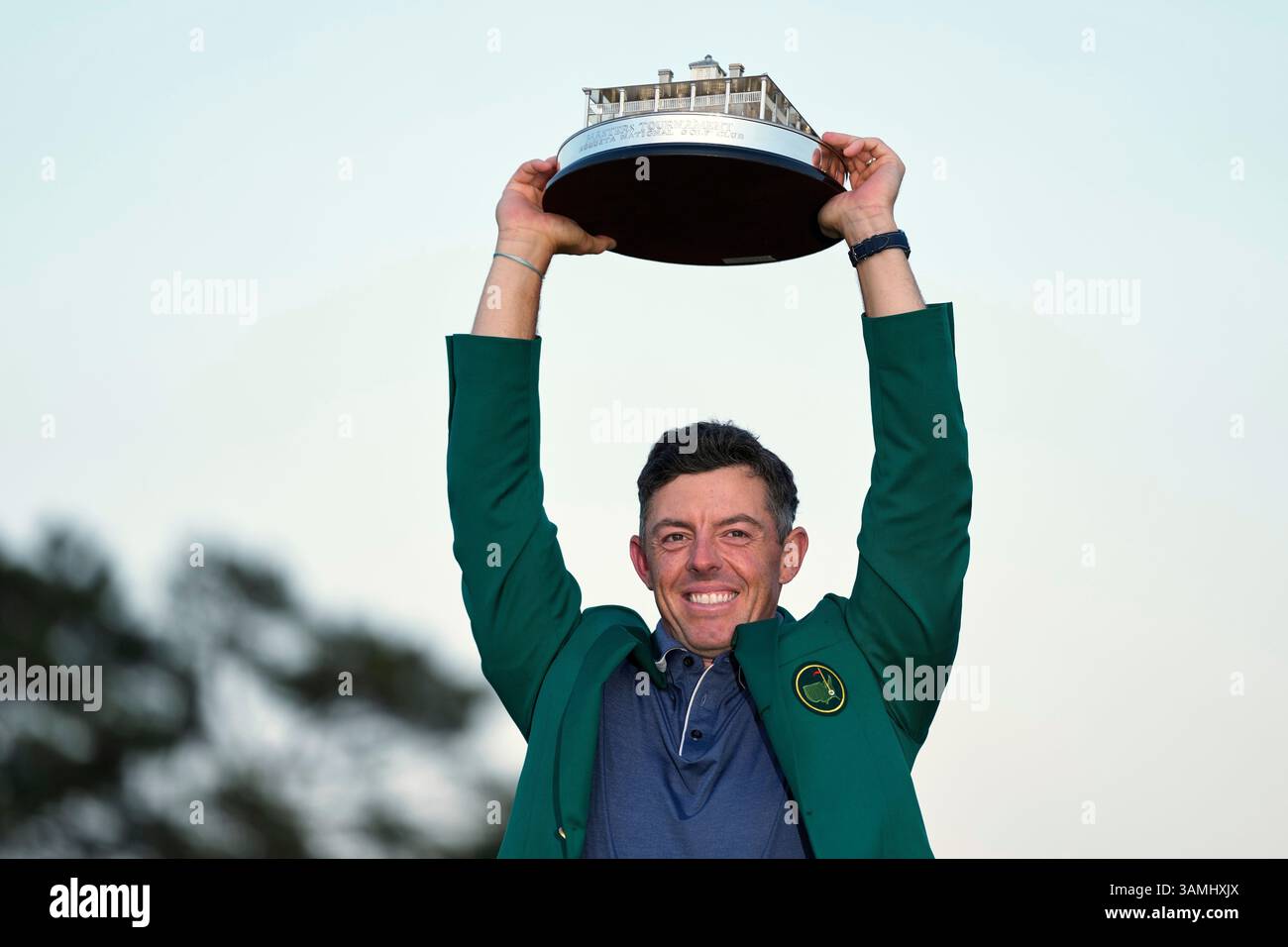 Winner Rory McIlroy, of Northern Ireland, holds the trophy at the ...