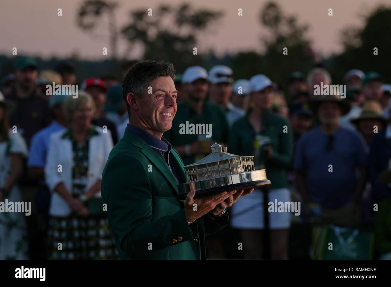 Rory McIlroy, of Northern Ireland, holds the trophy after winning the ...