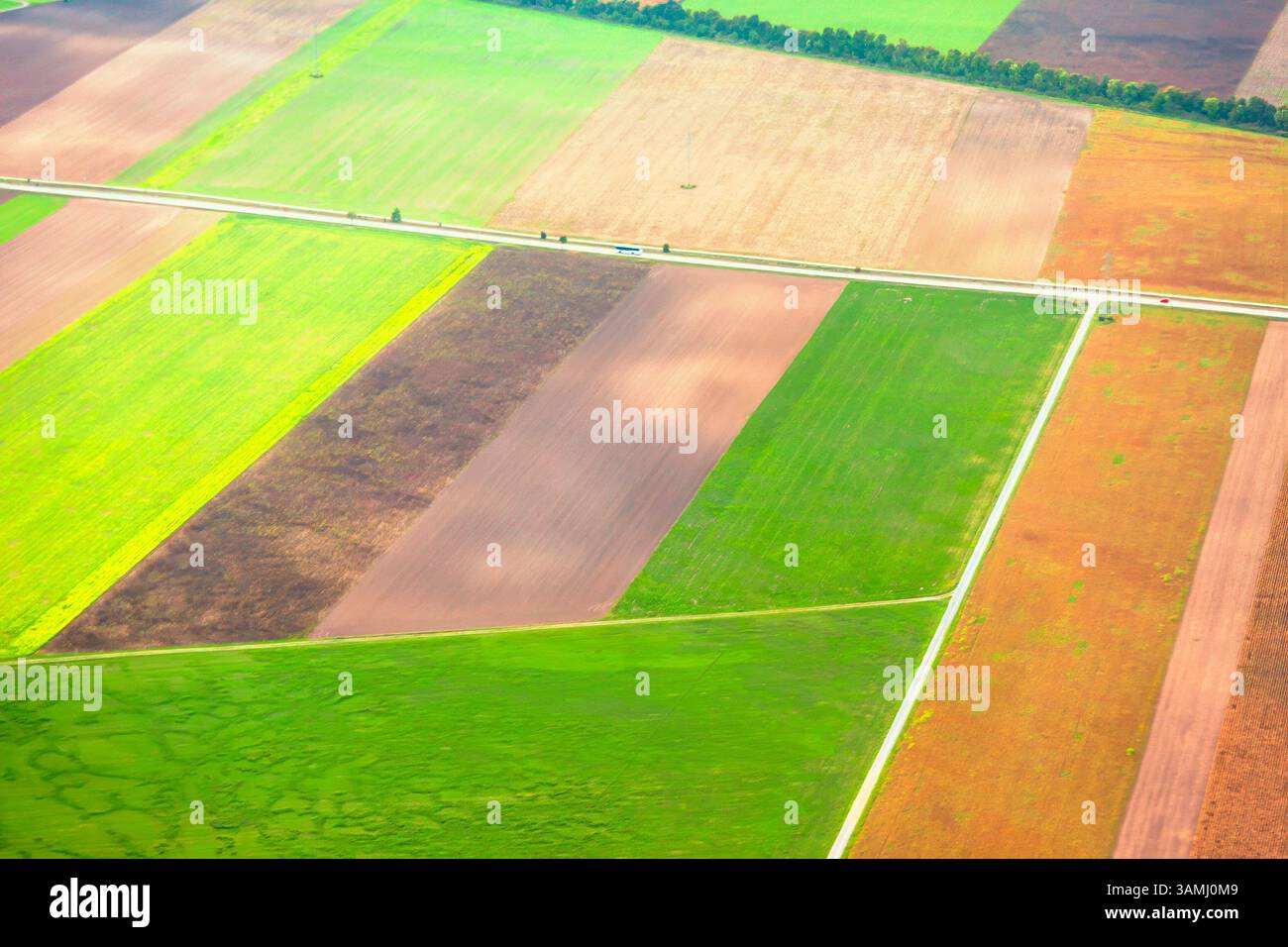 Aerial view showcases a patchwork of green and brown fields divided by ...