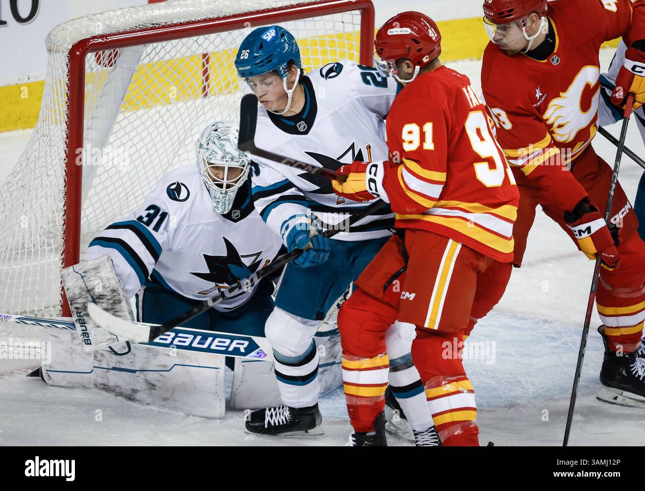 San Jose Sharks' Jack Thompson (26) checks Calgary Flames' Nazem Kadri ...