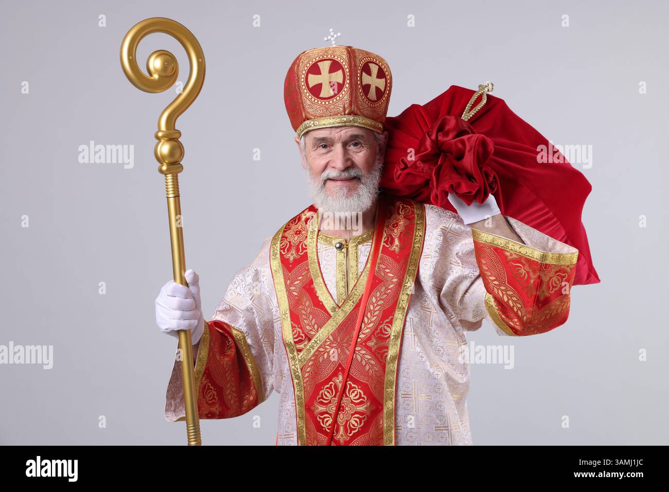 Saint Nicholas with sack on light grey background Stock Photo - Alamy