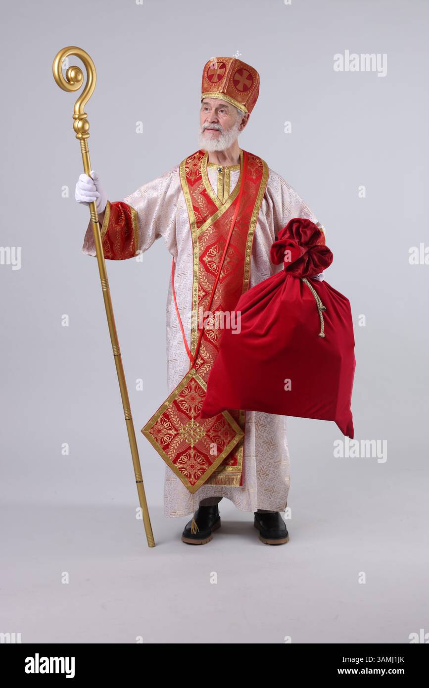 Saint Nicholas with sack on light grey background Stock Photo - Alamy
