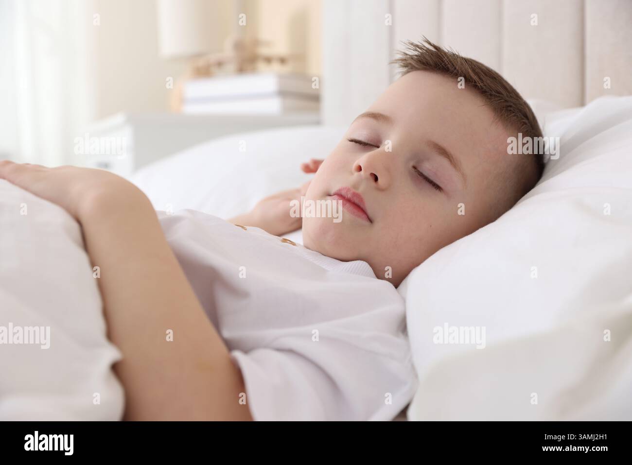 Bedtime. Cute boy sleeping in comfortable bed Stock Photo - Alamy