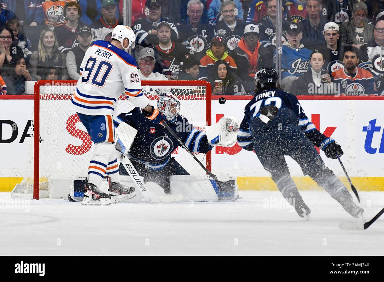 Winnipeg Jets' goaltender Eric Comrie (1) makes a save on Edmonton ...