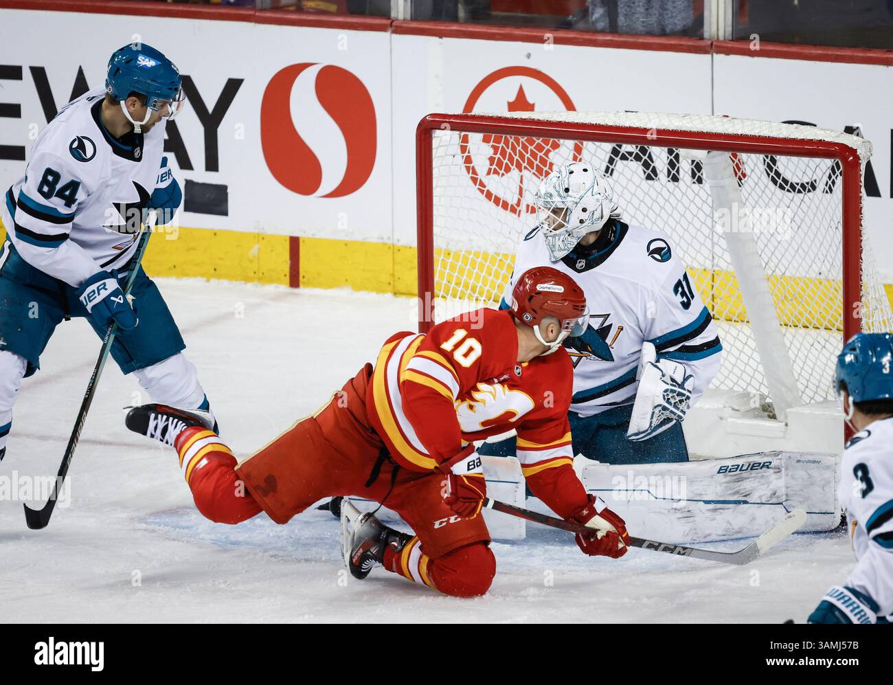 San Jose Sharks' Jan Rutta (84) knocks Calgary Flames' Jonathan ...