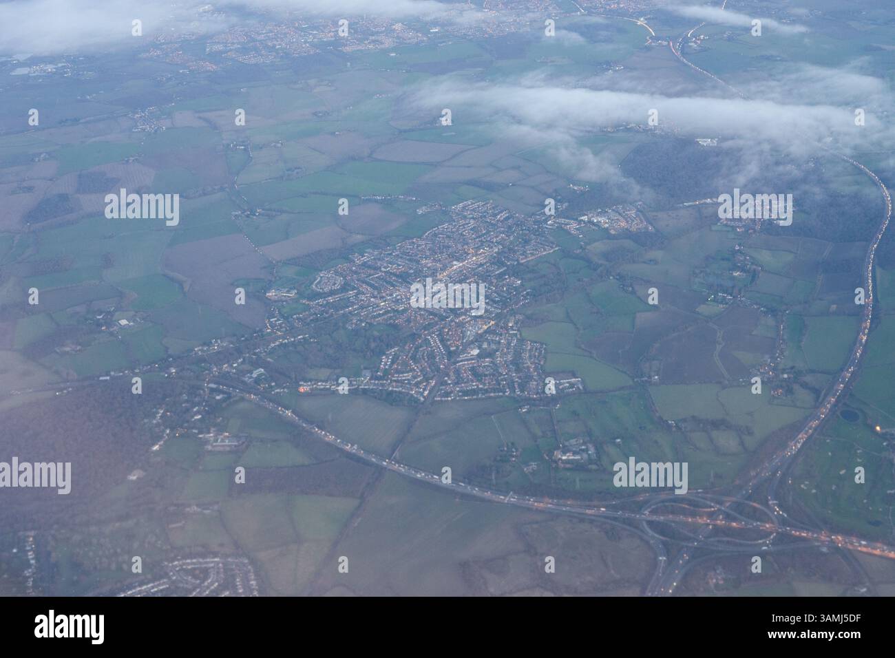 Aerial view of London through early morning clouds at golden hour ...