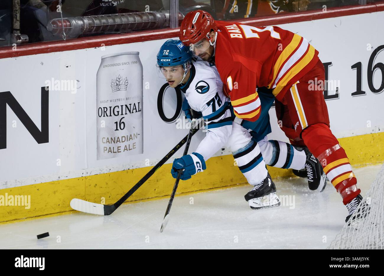 San Jose Sharks' William Eklund (72) is checked by Calgary Flames ...