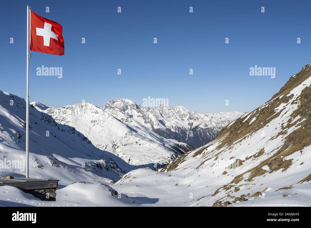 Swiss flag in front of mountain landscape in winter, mountain panorama ...
