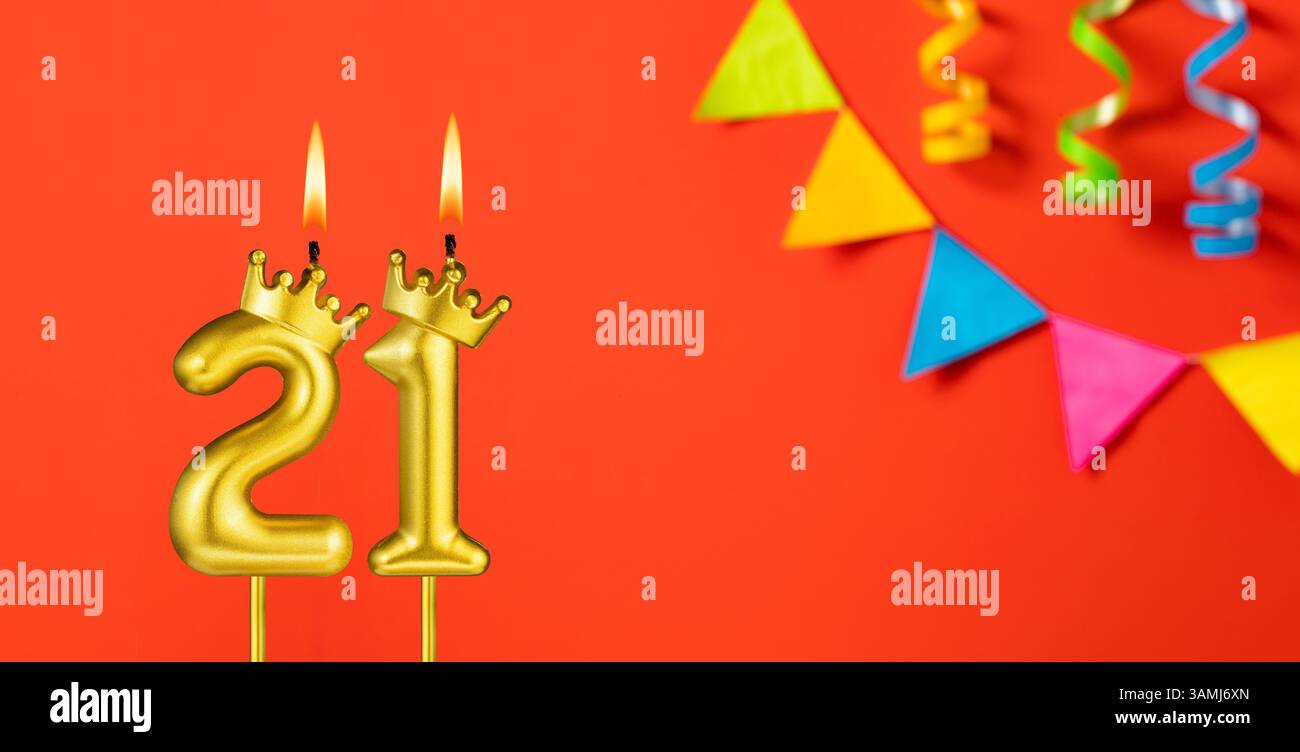 Number 21 birthday candle on an orange background with pennants Stock ...