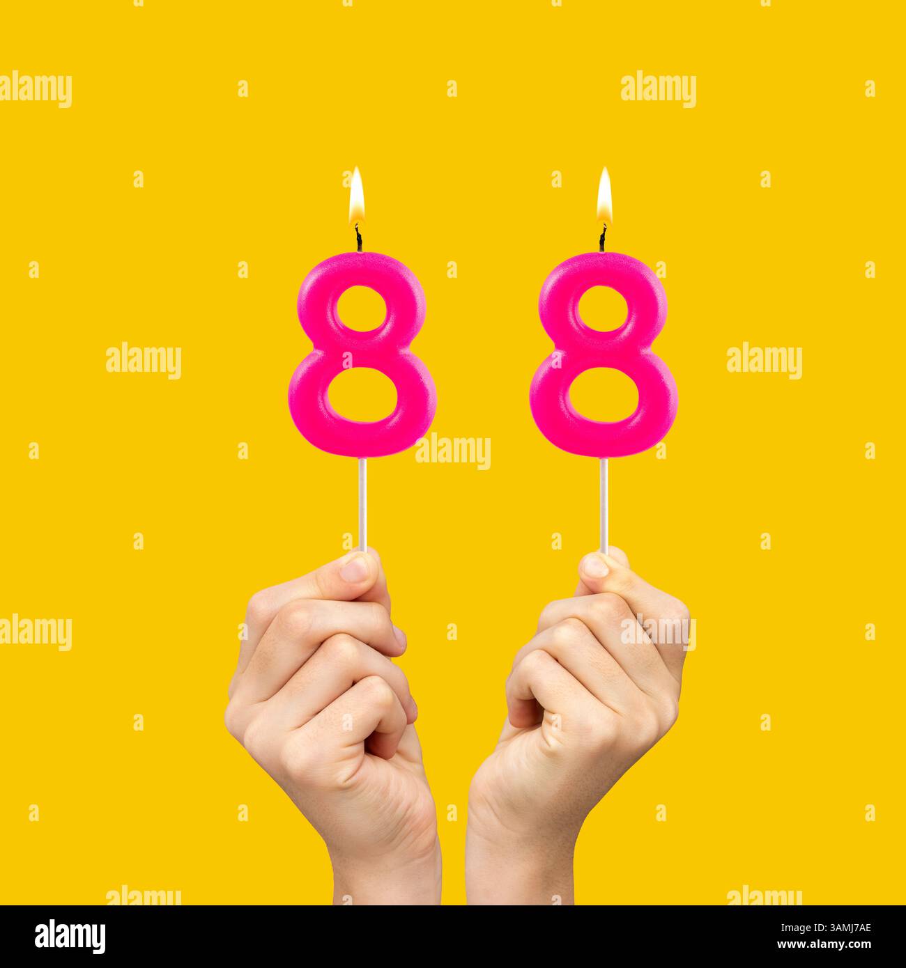 Hands holding birthday candles with number 88 - Yellow background Stock ...