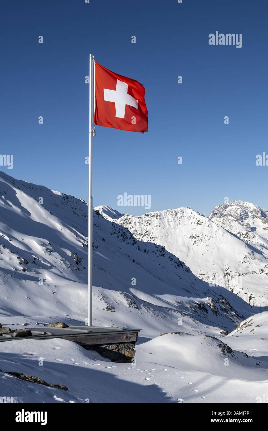 Swiss flag in front of mountain landscape in winter, mountain panorama ...