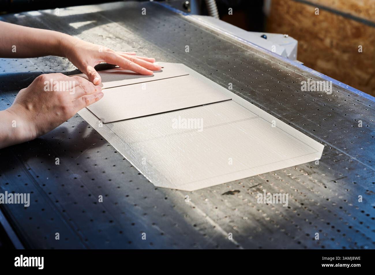 Manual cardboard application in a box manufacturing plant showcasing ...