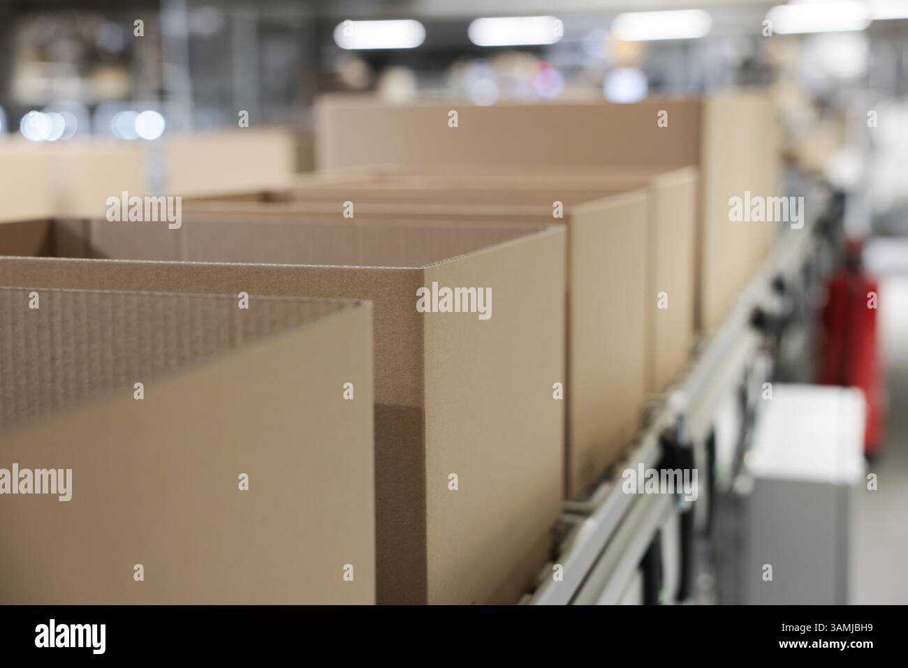 Empty cartons, parcels for goods dispatch on a conveyor belt, conveyor ...