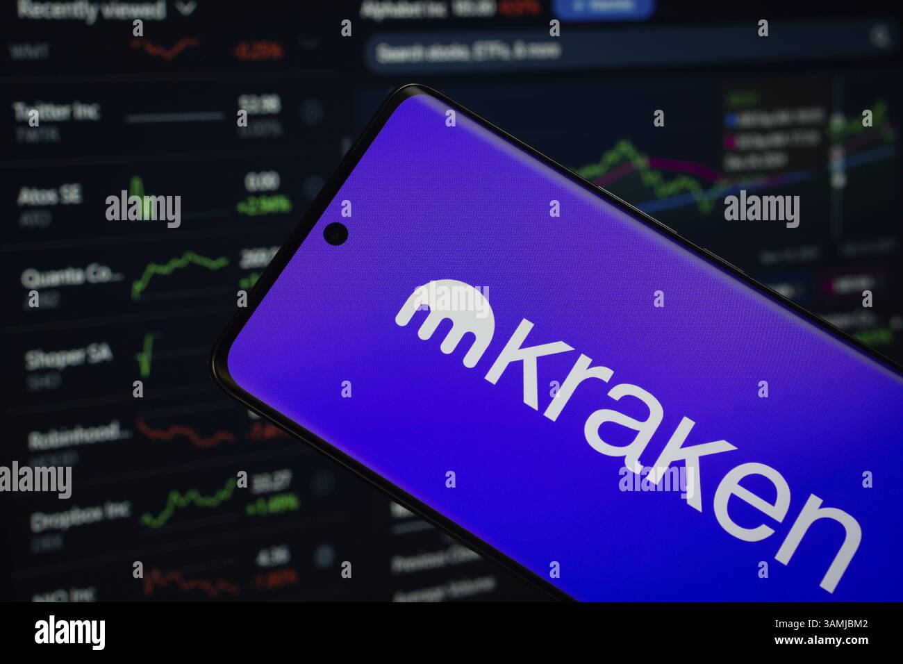 kraken logo is displayed on a smartphone screen, with a stock graph ...