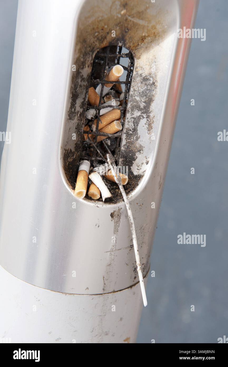 Very dirty modern ash tray outdoor Stock Photo - Alamy