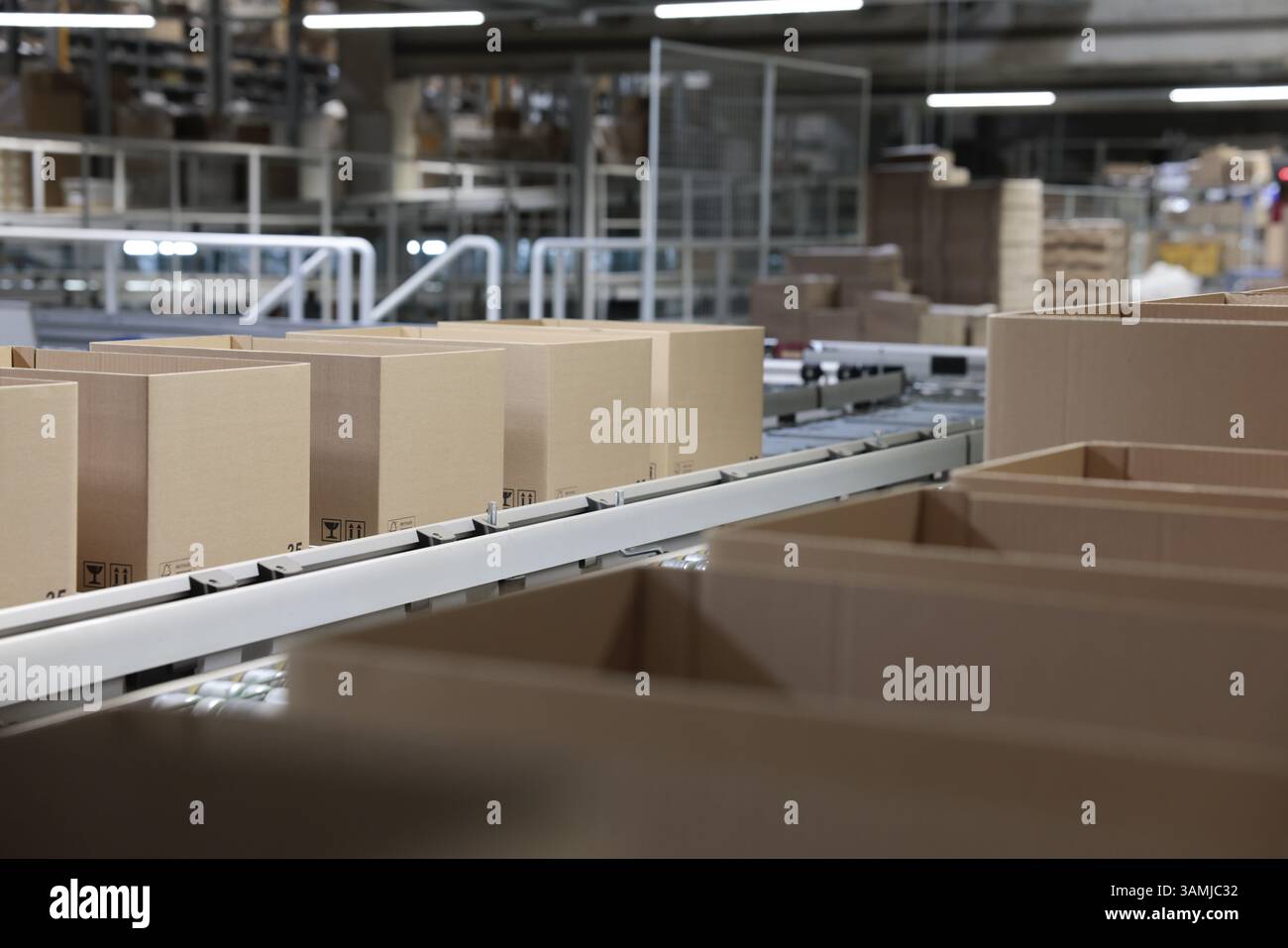 Empty cartons, parcels for goods dispatch on a conveyor belt, conveyor ...