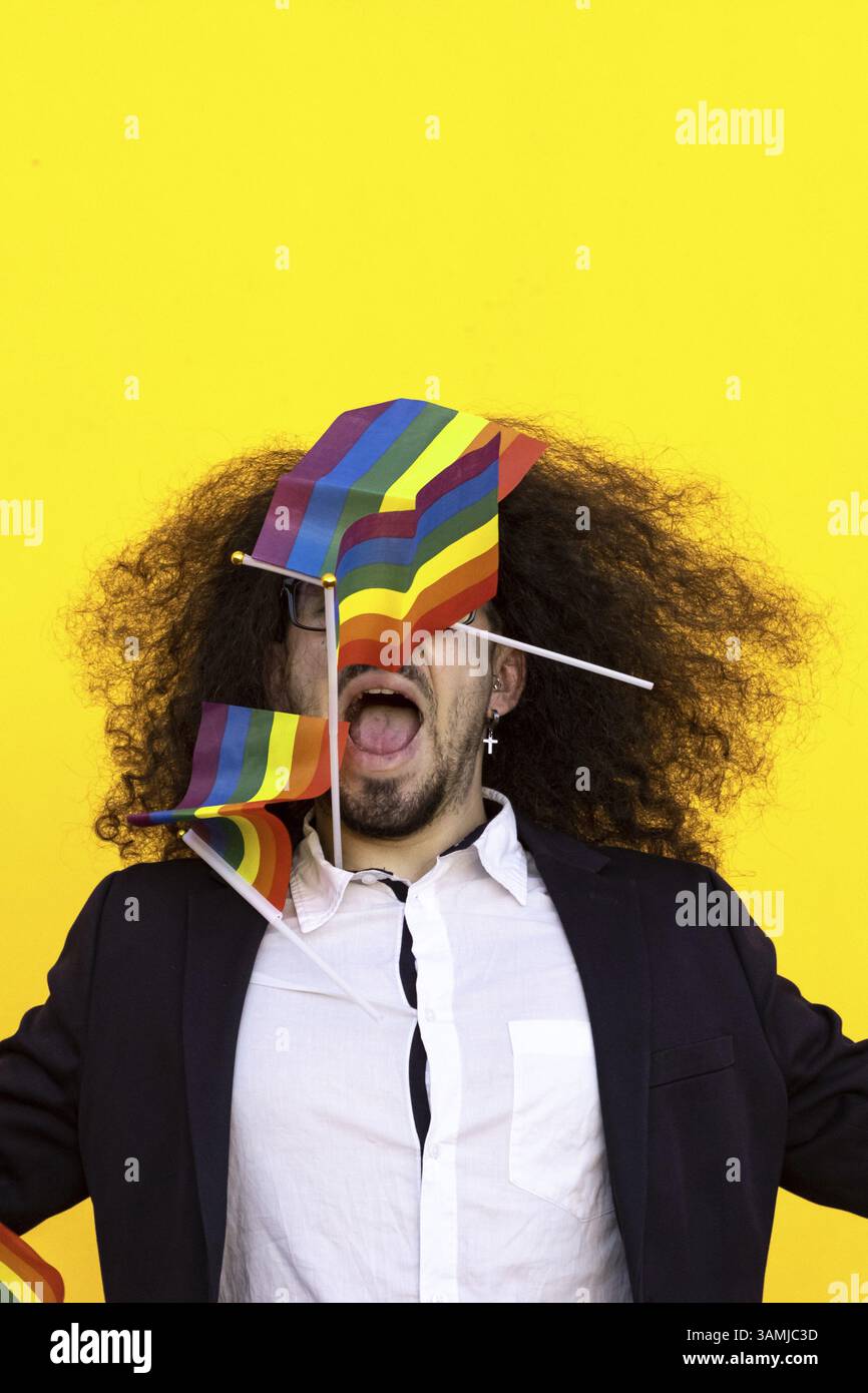 Man in formal suit holding rainbow flag isolated. Business man holding ...
