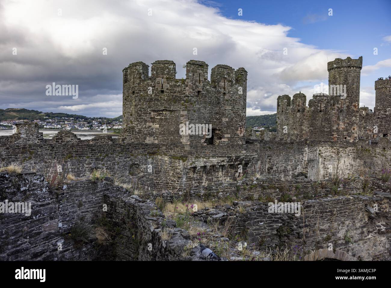 Old castle with massive stone towers and clouds in the background Stock ...