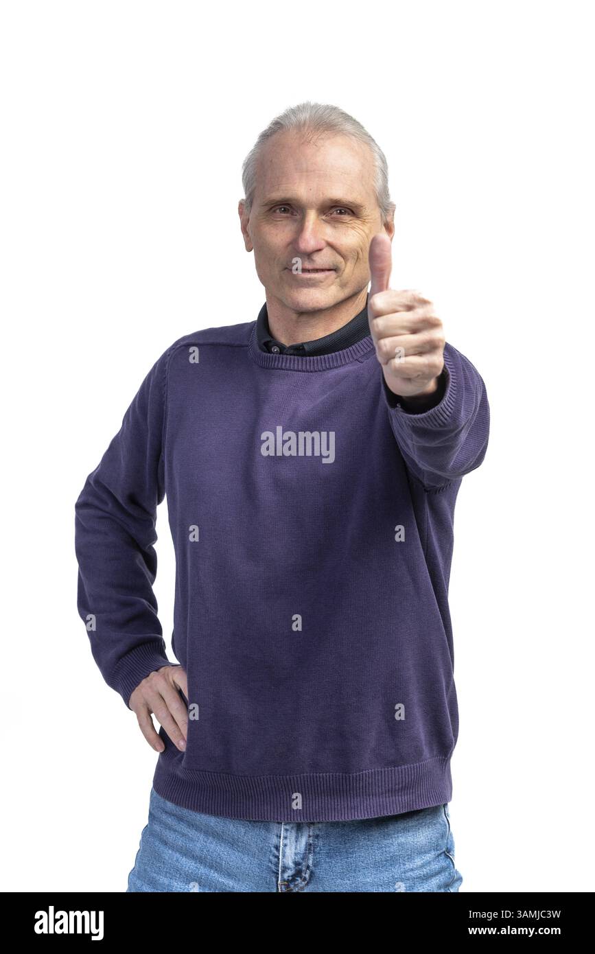 Smiling mature man gesturing thumbs up, showing approval and agreement ...