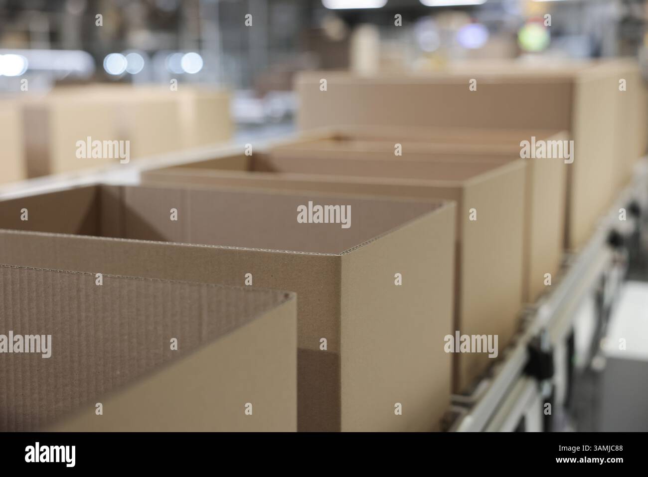 Empty cartons, parcels for goods dispatch on a conveyor belt, conveyor ...
