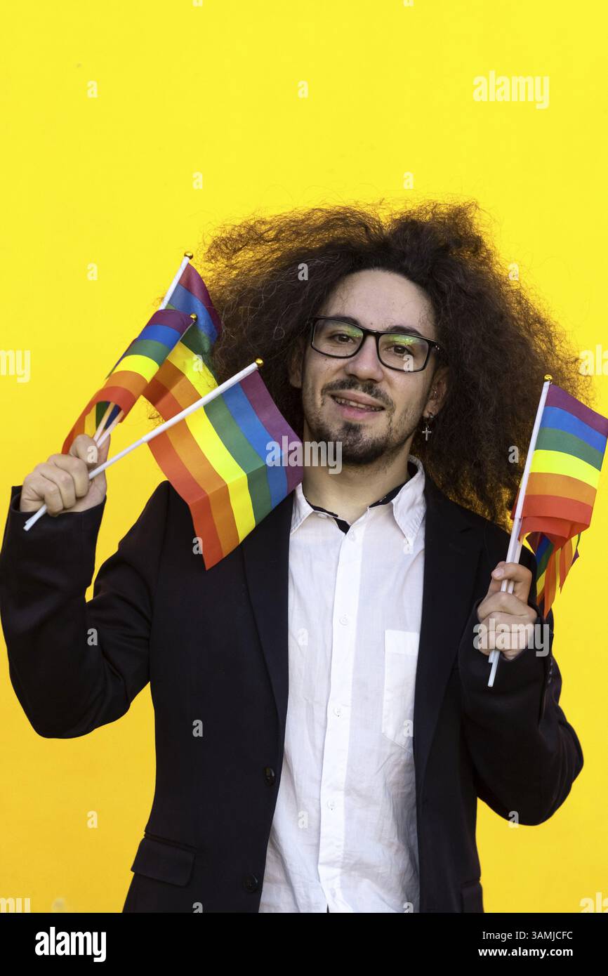 Business man holding rainbow flag. Man in formal suit holding rainbow ...