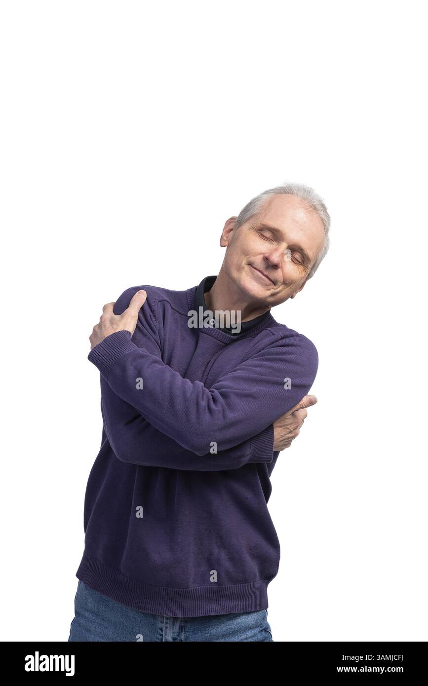 Happy retired man embracing himself with closed eyes, enjoying moment ...
