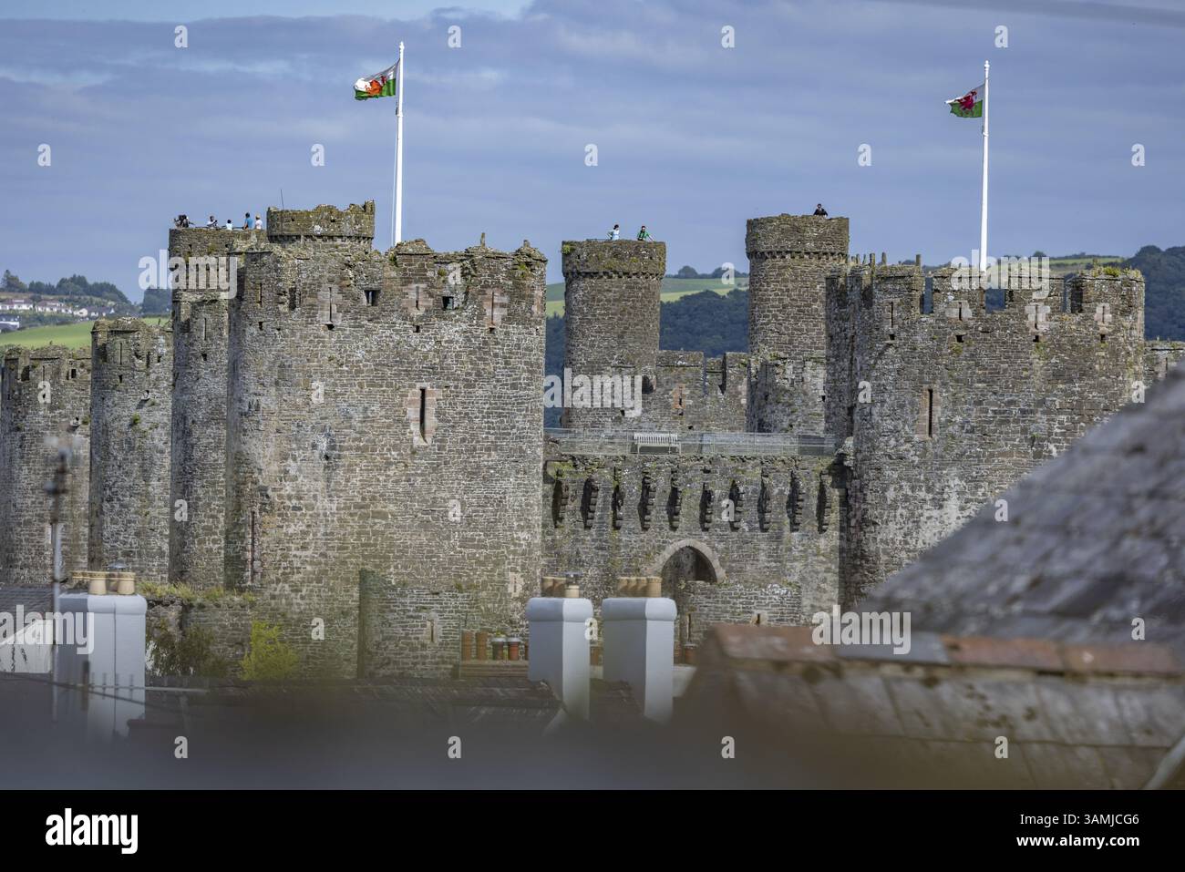 Conwy Castle, medieval castle with towers and flags in an urban setting ...