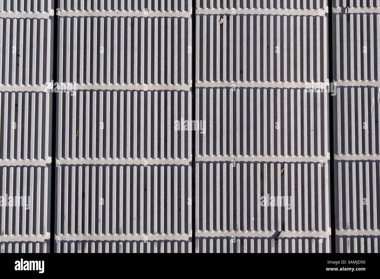 Grey rectangular tiles with vertical ridges close up textured ...