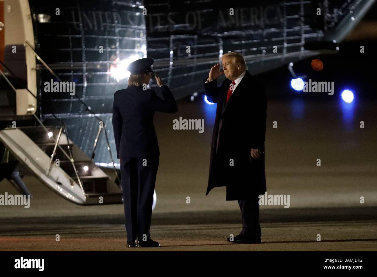 President Donald Trump, right, salutes Air Force Col. Angela F. Ochoa ...