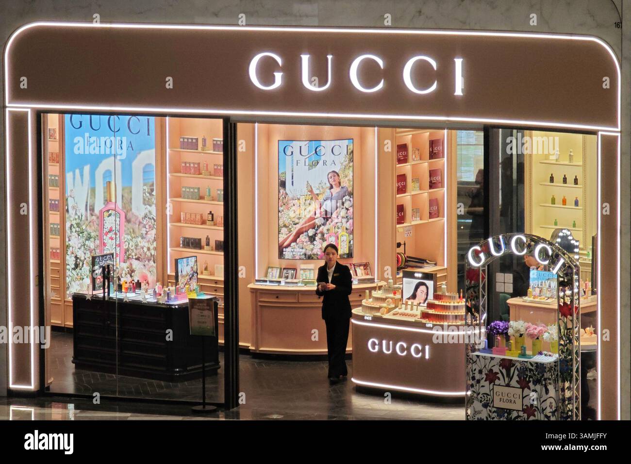 JINAN, CHINA - APRIL 4, 2025 - A Gucci shop assistant waits for ...