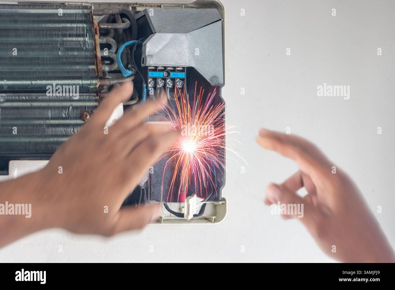 Electrical short circuit during air conditioner maintenance Stock Photo ...