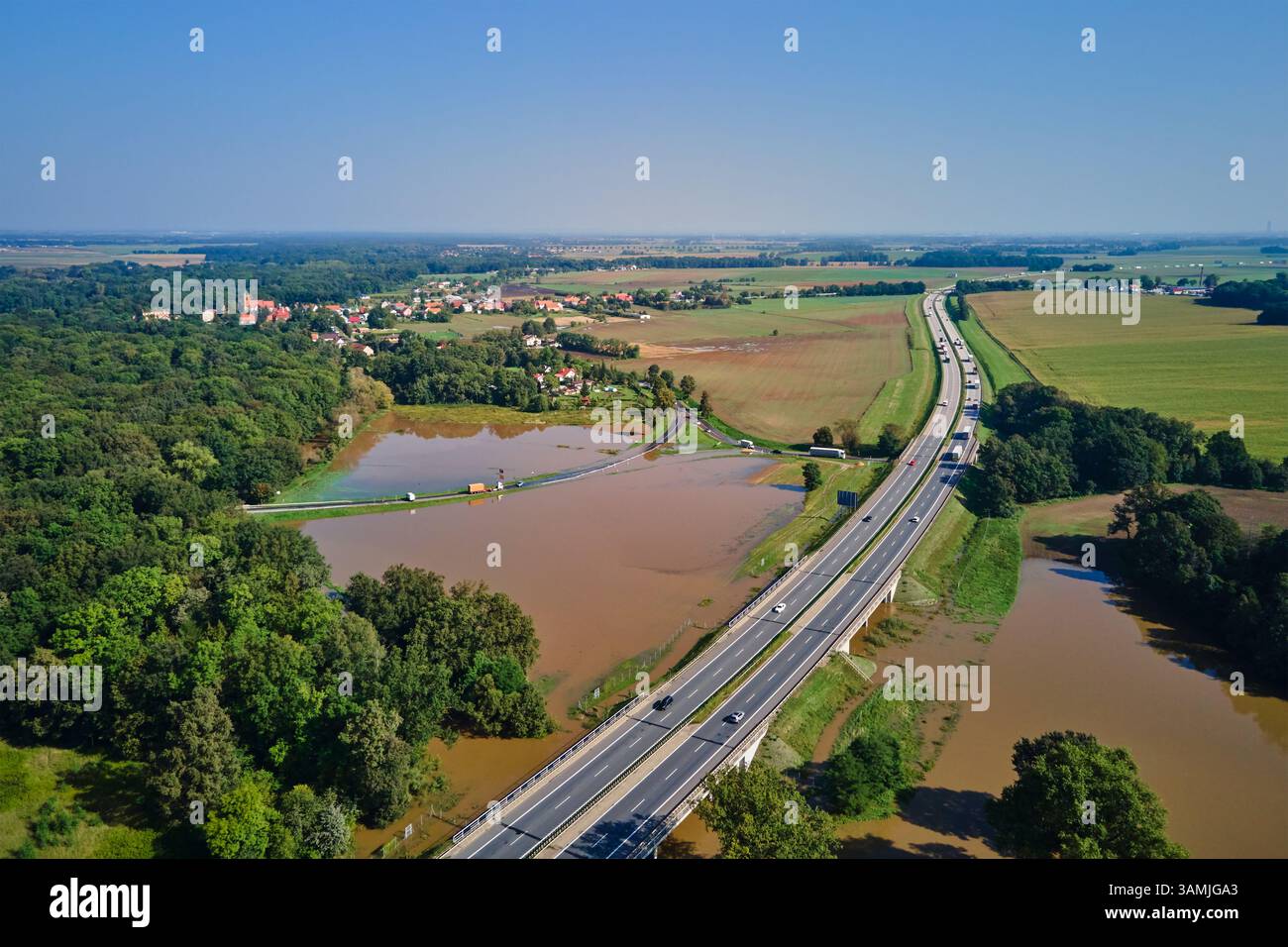 Aerial view of flooded fields and submerged rural road near busy ...