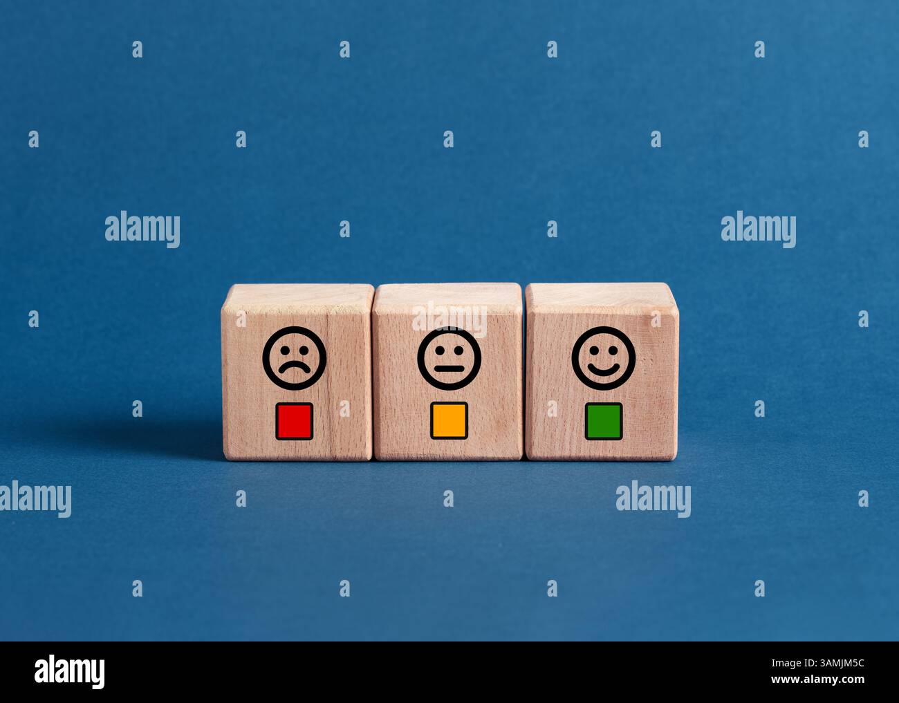 Wooden blocks showing satisfaction level with emoji faces and ...
